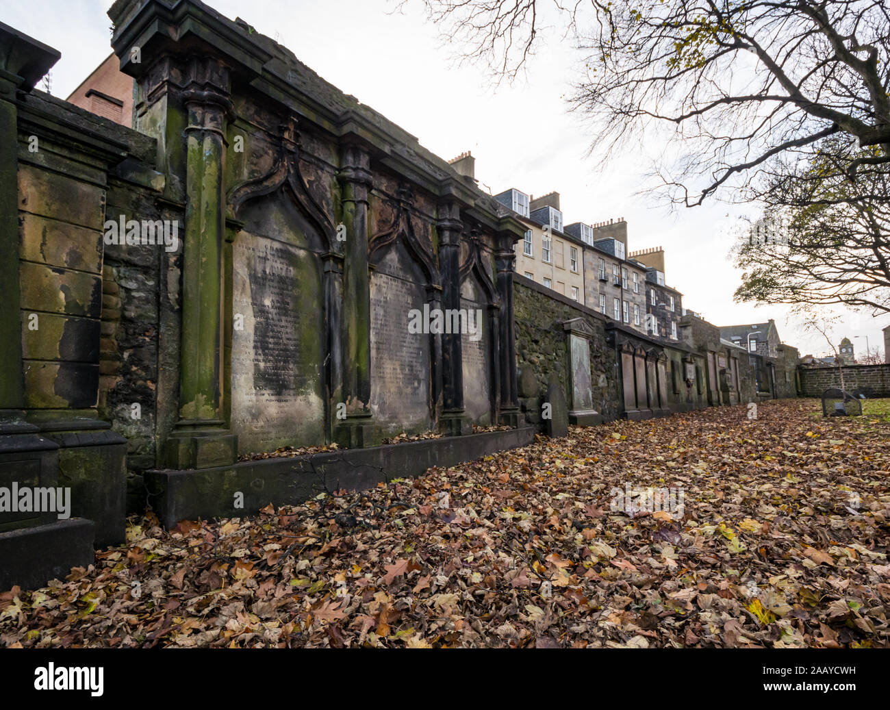 Old churchyard wall with tombs and graves, due to be rebuilt as part of ...