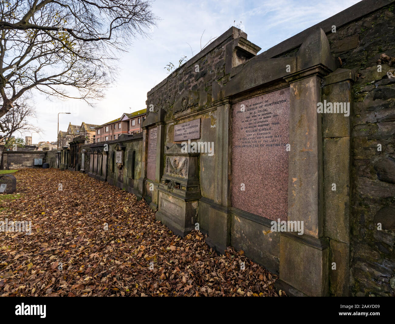 Old churchyard wall with tombs and graves, due to be rebuilt as part of ...
