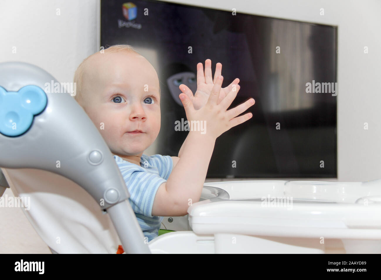 Photo of the One year Baby watching cartoons on TV and playing Stock ...