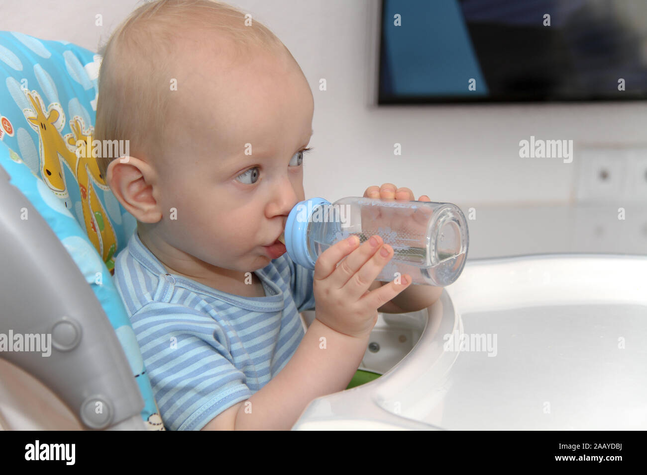 Photo of the One year Baby watching cartoons on TV and playing Stock ...