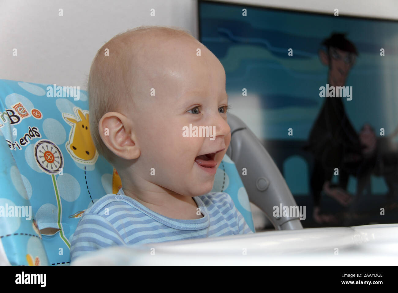 Photo of the One year Baby watching cartoons on TV and playing Stock ...