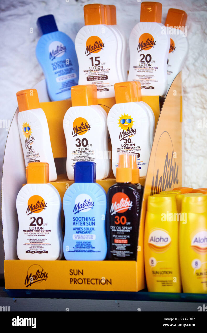 Display of Malibu branded sun cream bottles in a beachside cafe in ...