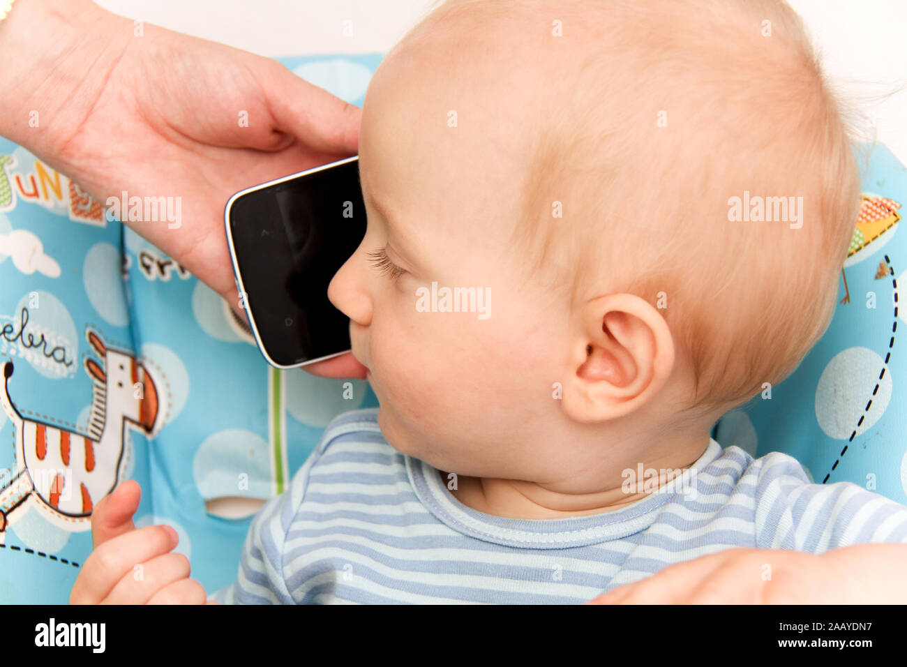 Photo of the One year Baby watching cartoons on TV and playing Stock ...