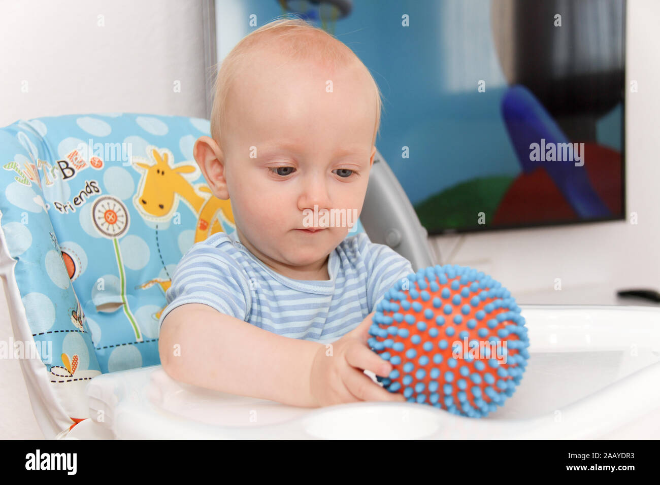 Photo of the One year Baby watching cartoons on TV and playing Stock ...