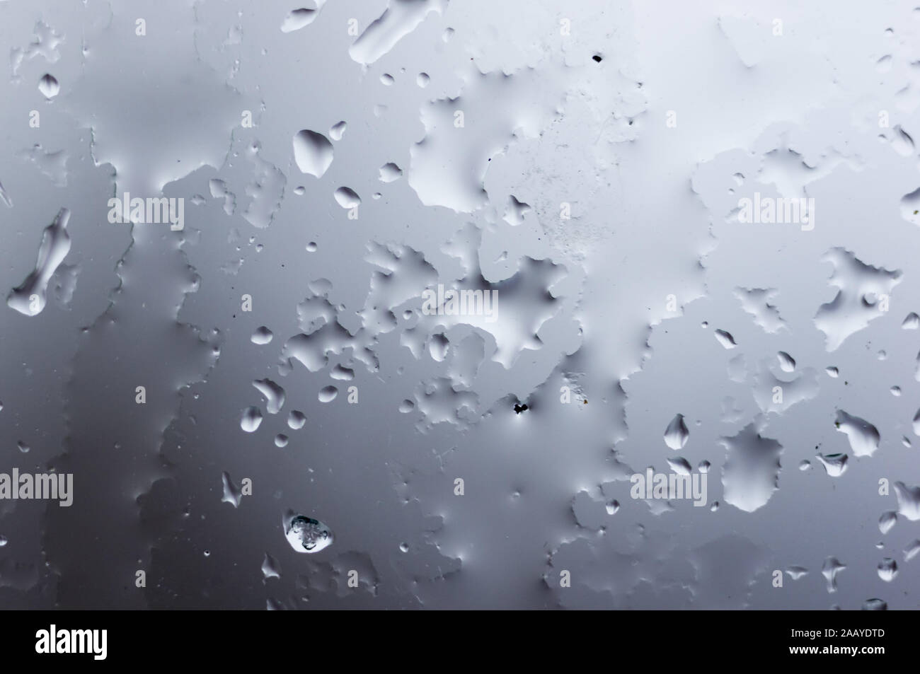 glass in the window covered with wet melting snow, close-up, macro ...