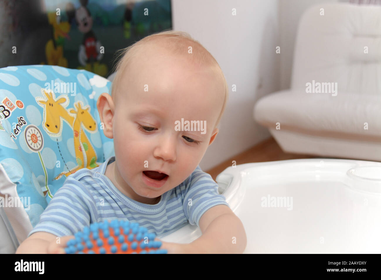 Photo of the One year Baby watching cartoons on TV and playing Stock ...