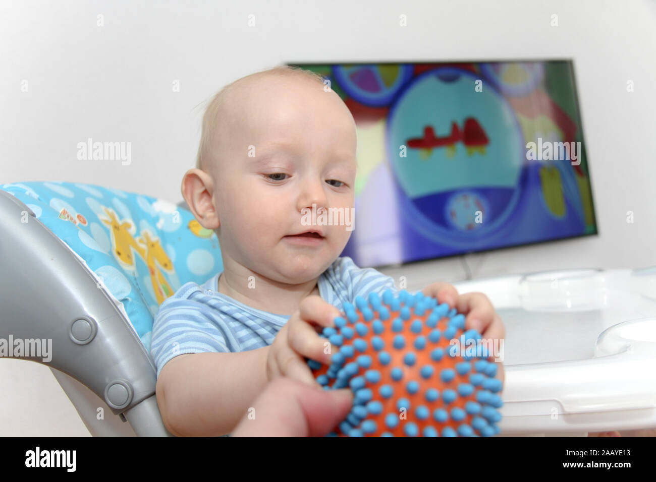 Photo of the One year Baby watching cartoons on TV and playing Stock ...