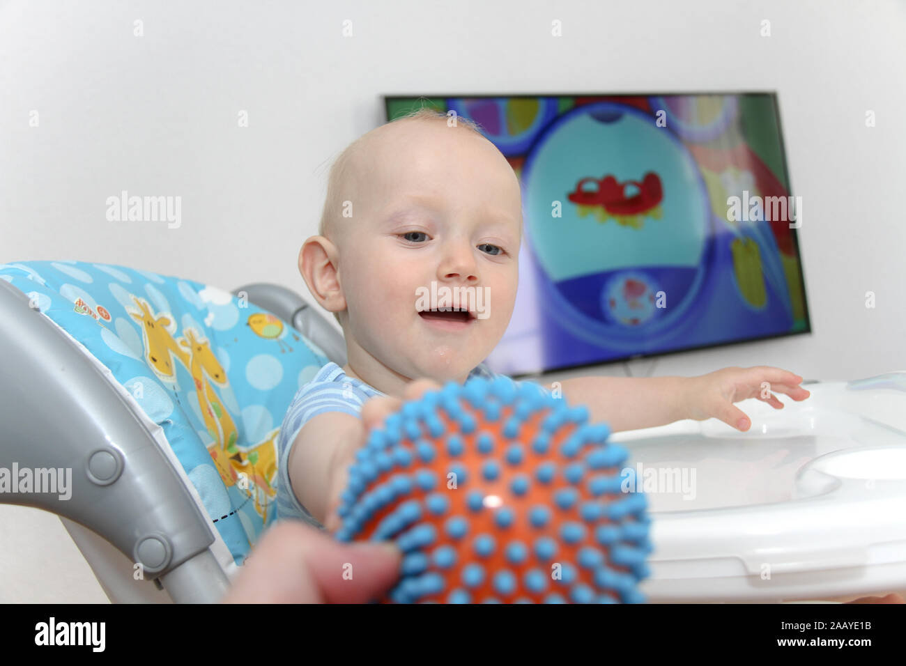 Photo of the One year Baby watching cartoons on TV and playing Stock ...
