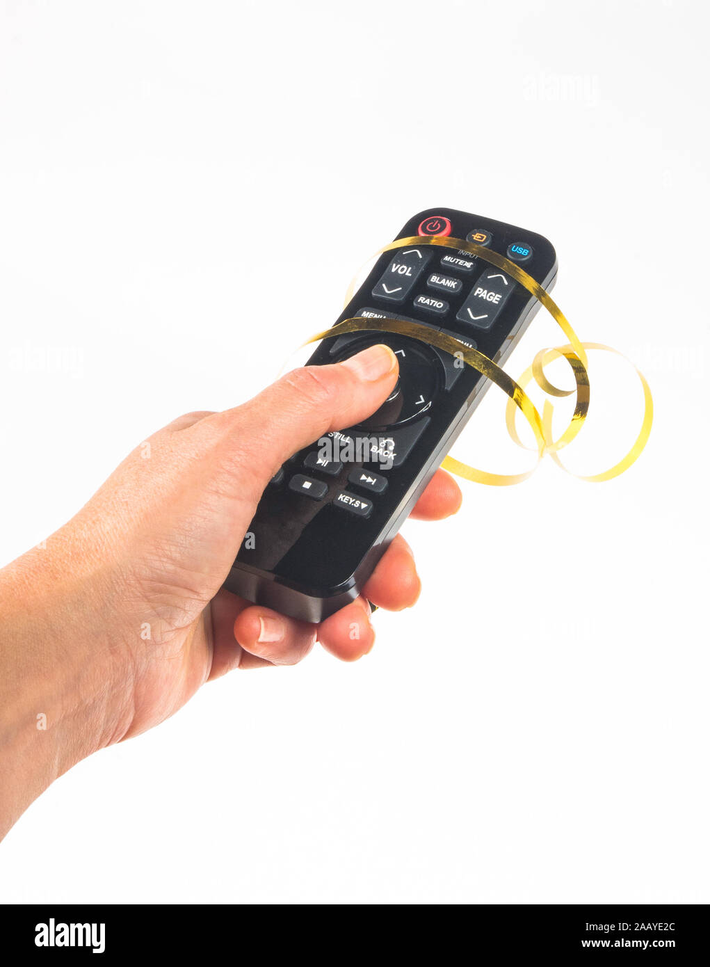 hand holding a remote control in a festive gold ribbon on white ...