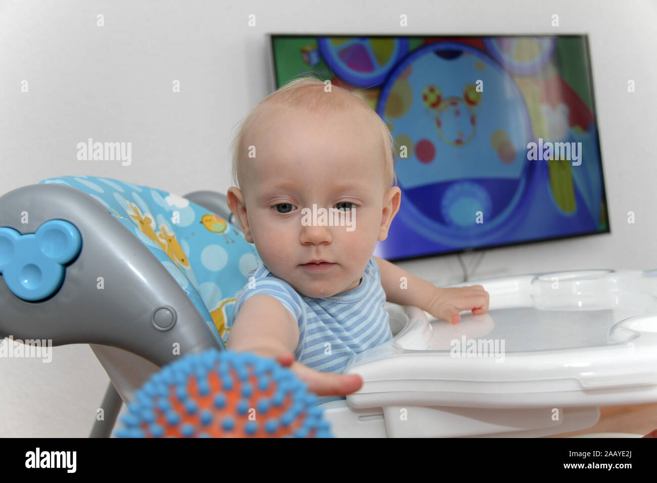 Photo of the One year Baby watching cartoons on TV and playing Stock ...