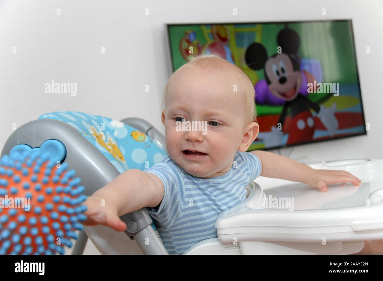 Photo of the One year Baby watching cartoons on TV and playing Stock ...
