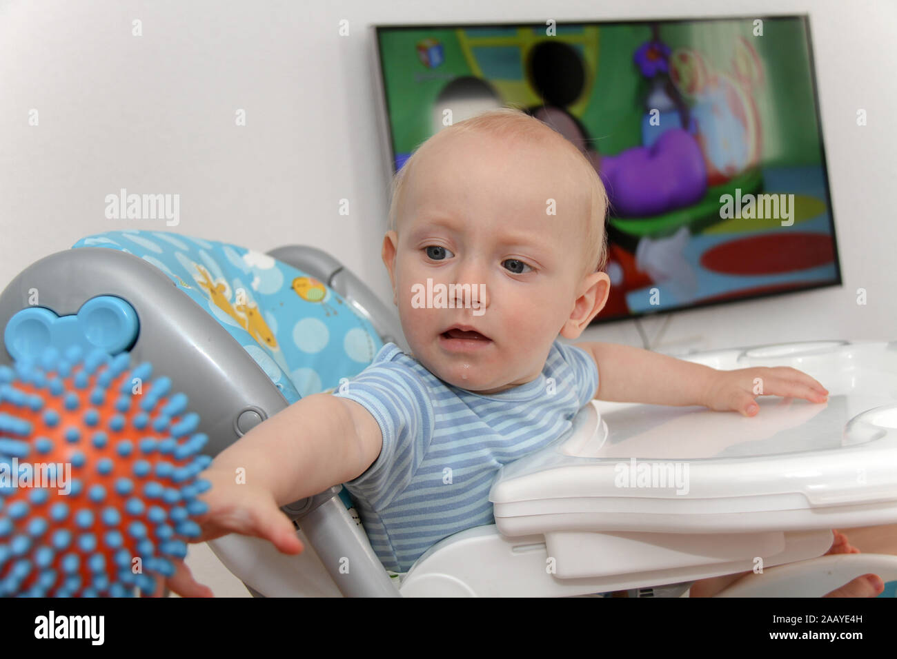 Photo of the One year Baby watching cartoons on TV and playing Stock ...