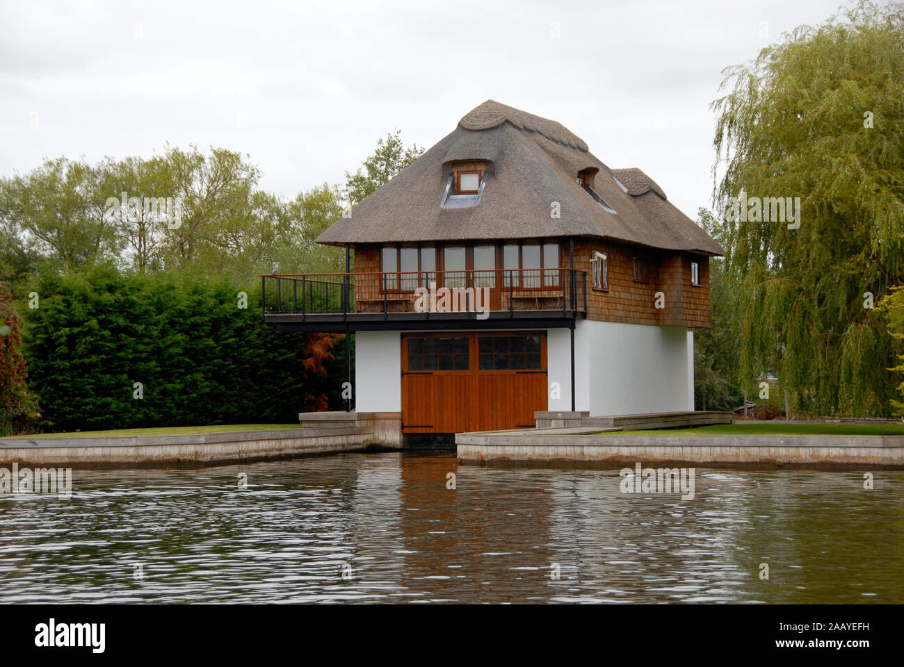 Attractive riverside thatched house built over boathouse, Norfolk ...