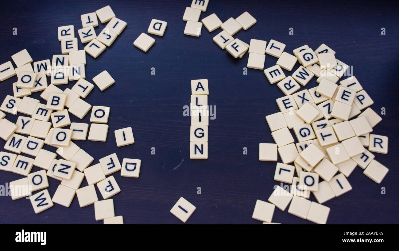 Align tile letters on a black background with mixed letters on either ...