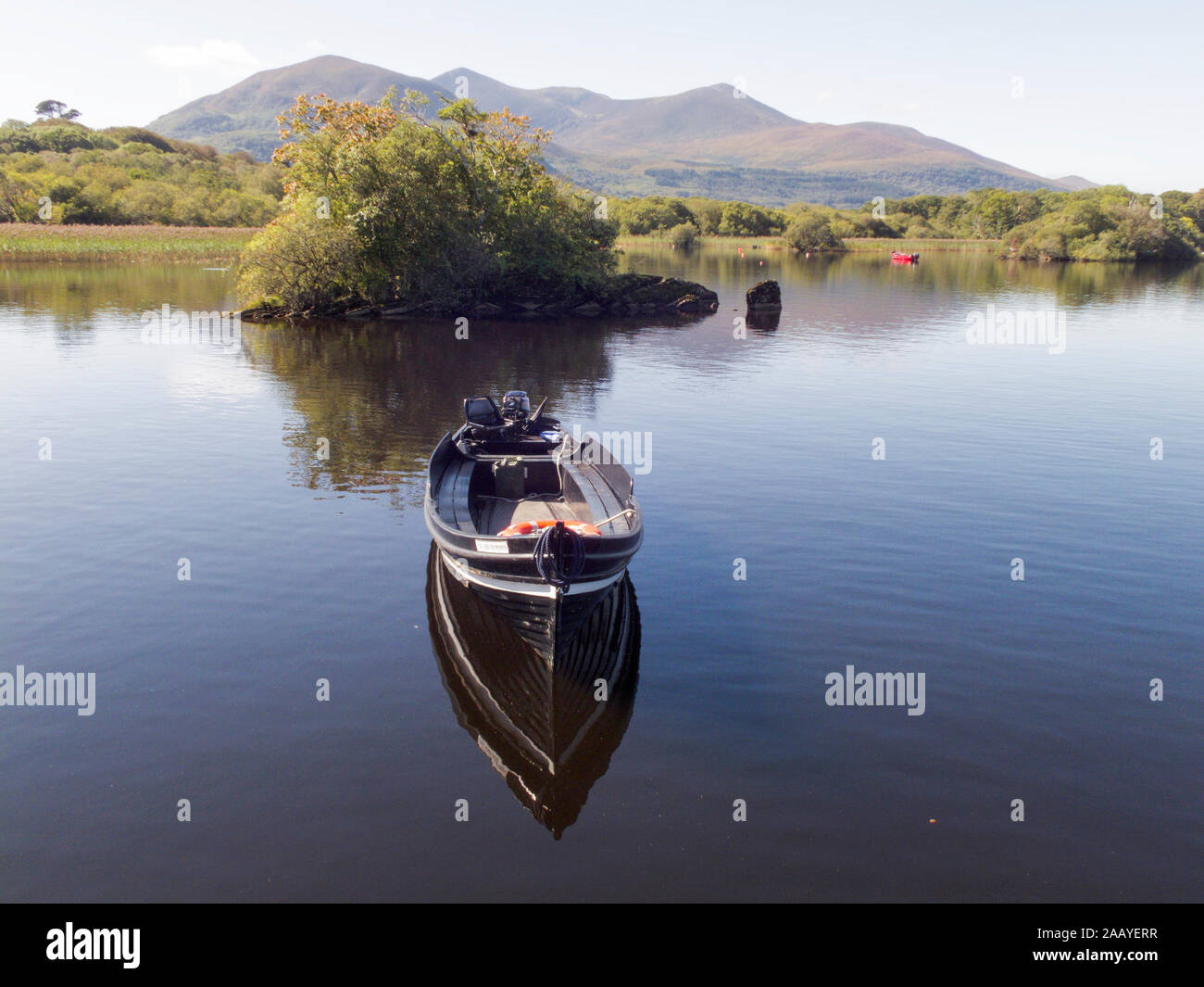 Image of an empty boat floating on a mountain lake Stock Photo - Alamy