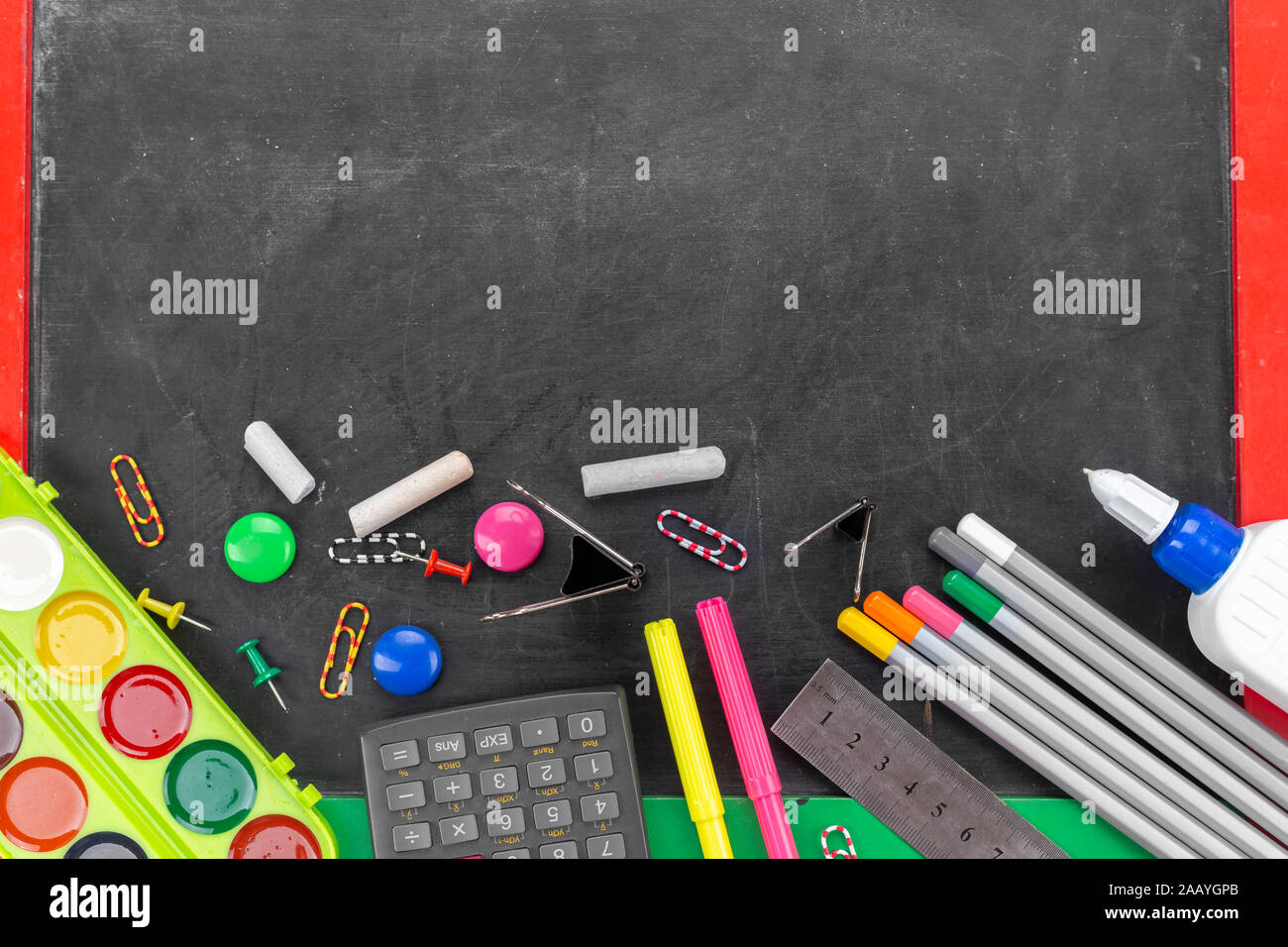 school supplies are scattered on a dark background. place for text ...