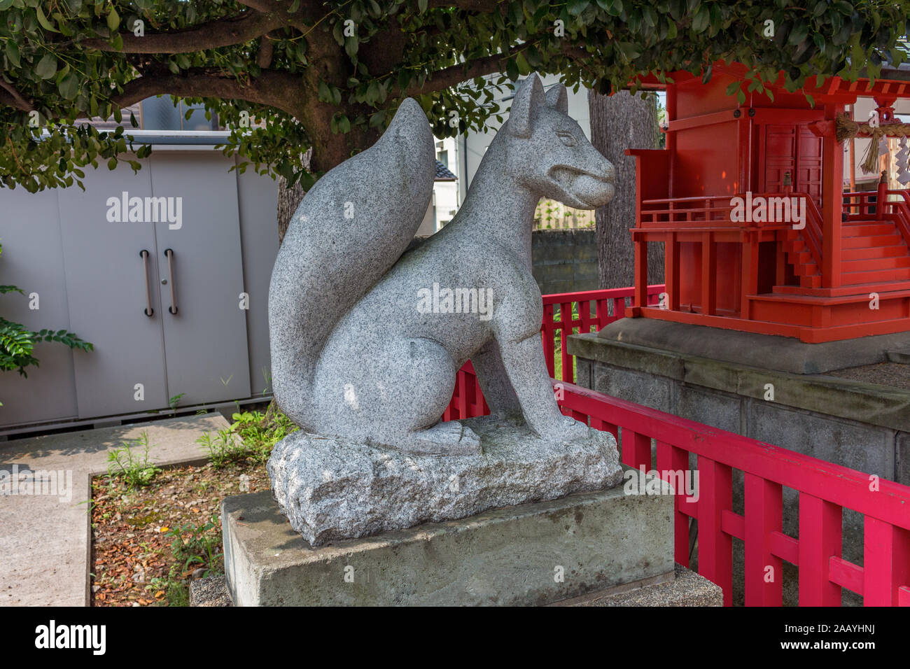 Historic stone statue of fox, or kitsune in Japanese, messenger of the ...