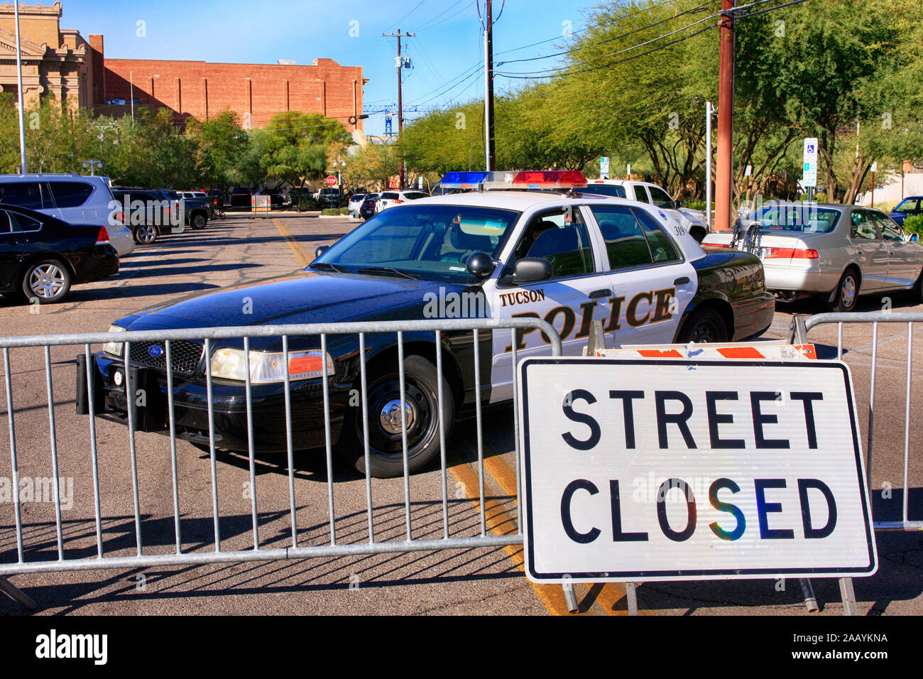 Street blocked off by railings and a police vehicle in Tucson AZ Stock ...