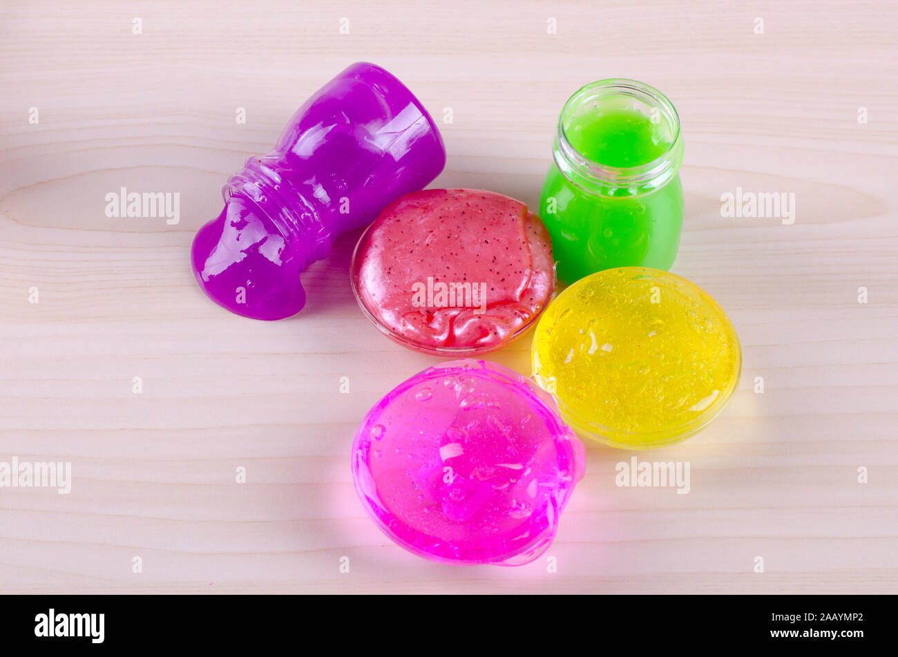 Bright multi colored slimes on a table. Kids most popular toy of ...