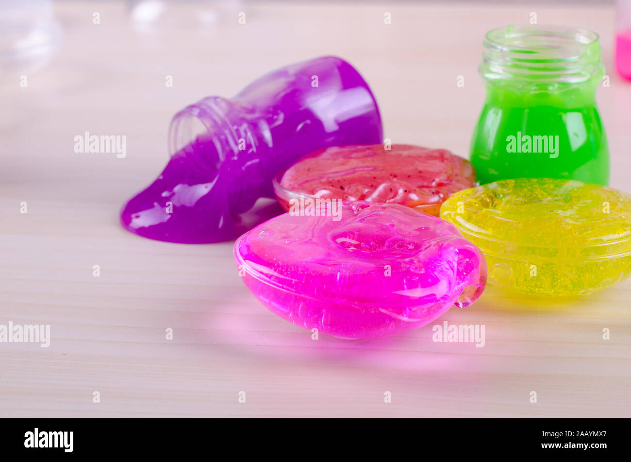 Bright multi colored slimes on a table. Kids most popular toy of ...