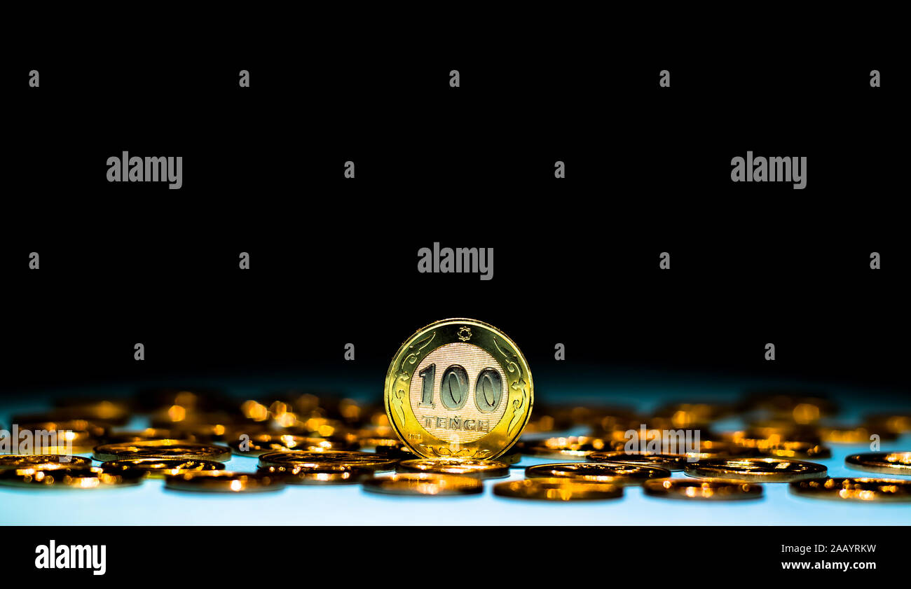 Tenge on a blue background with coins. Tenge coins of Kazakhstan Stock ...