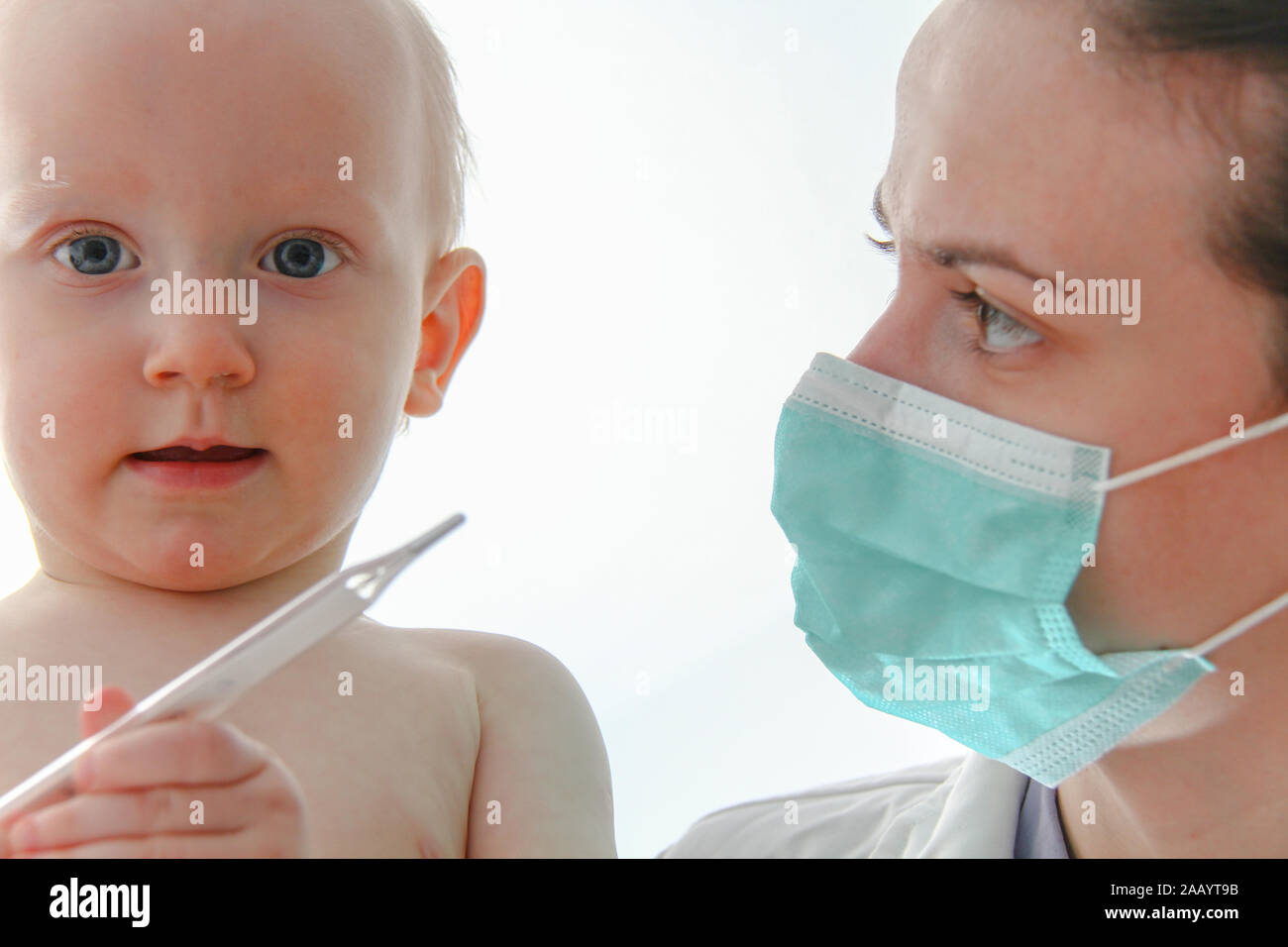 Photo of the One year old sick baby boy at the young female doctor ...