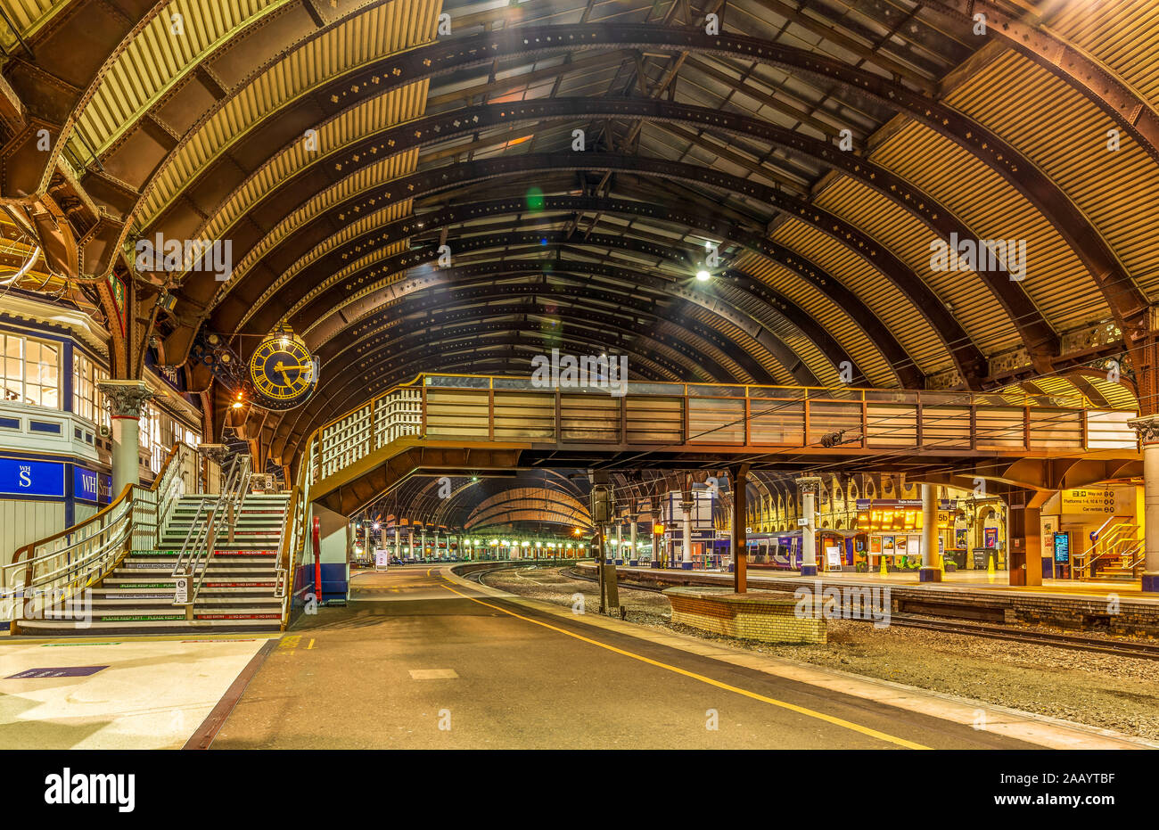 York Railway Station at night. Steps lead up to a footbridge while ...