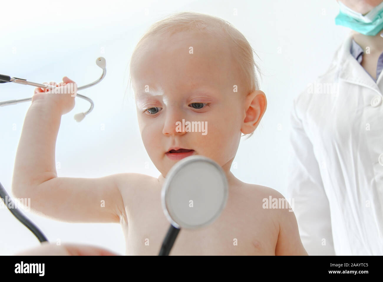 Photo of the One year old sick baby boy at the young female doctor ...
