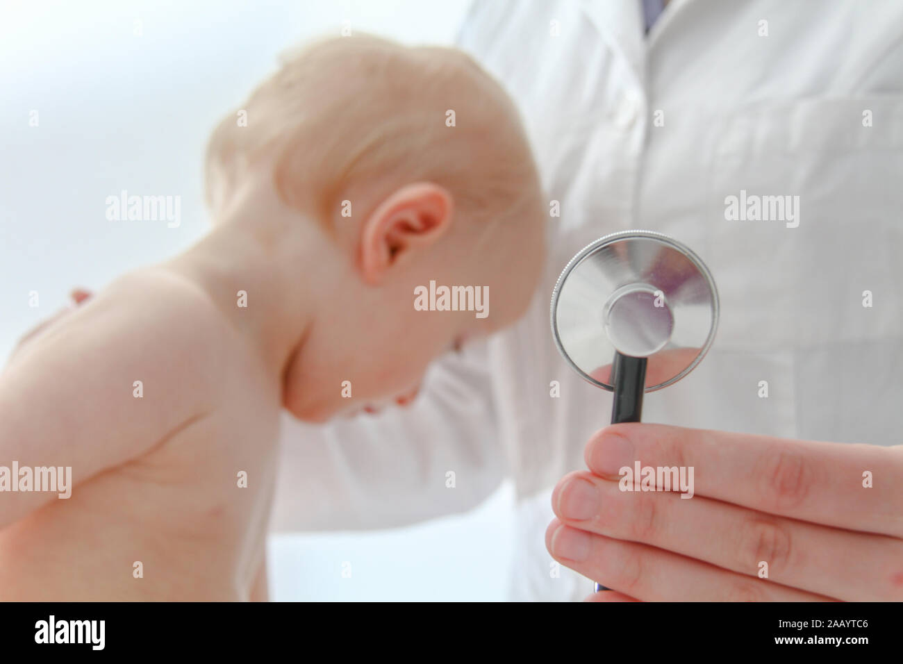 Photo of the One year old sick baby boy at the young female doctor ...