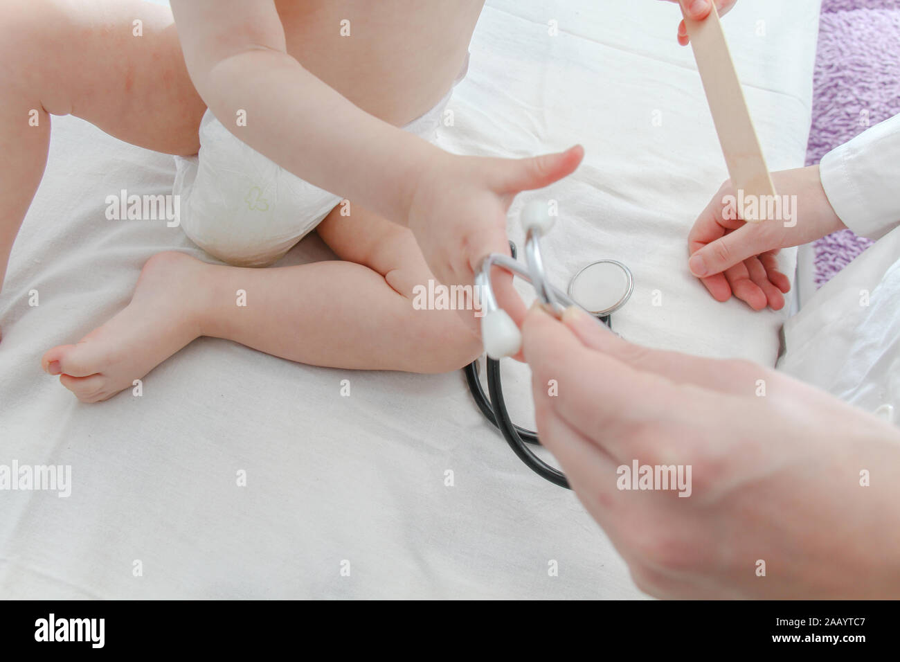 Photo of the One year old sick baby boy at the young female doctor ...