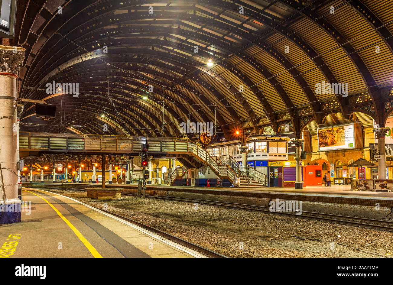York Railway Station at night. Steps lead up to a footbridge while ...