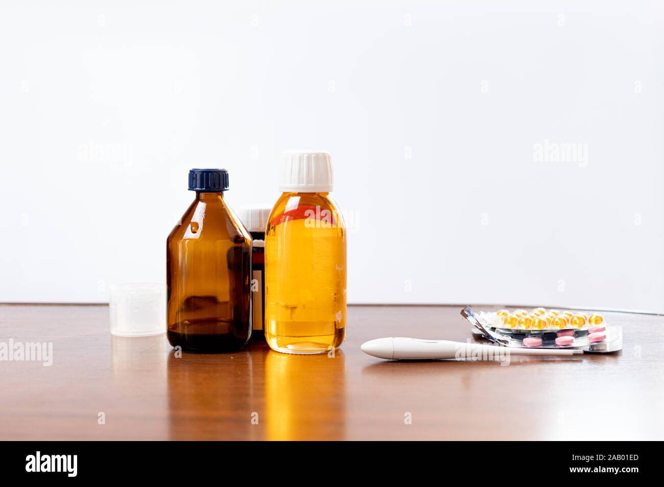 Small bottles with fluidity. Pills and syrup. Medicines Stock Photo - Alamy