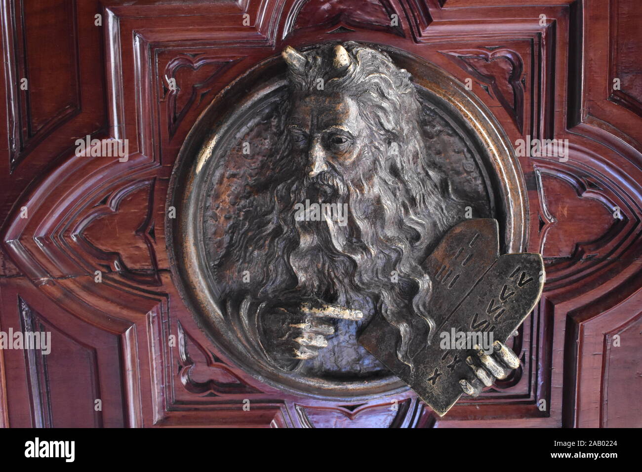 A sculpted bronze depiction of Moses with horns on the doors of the ...