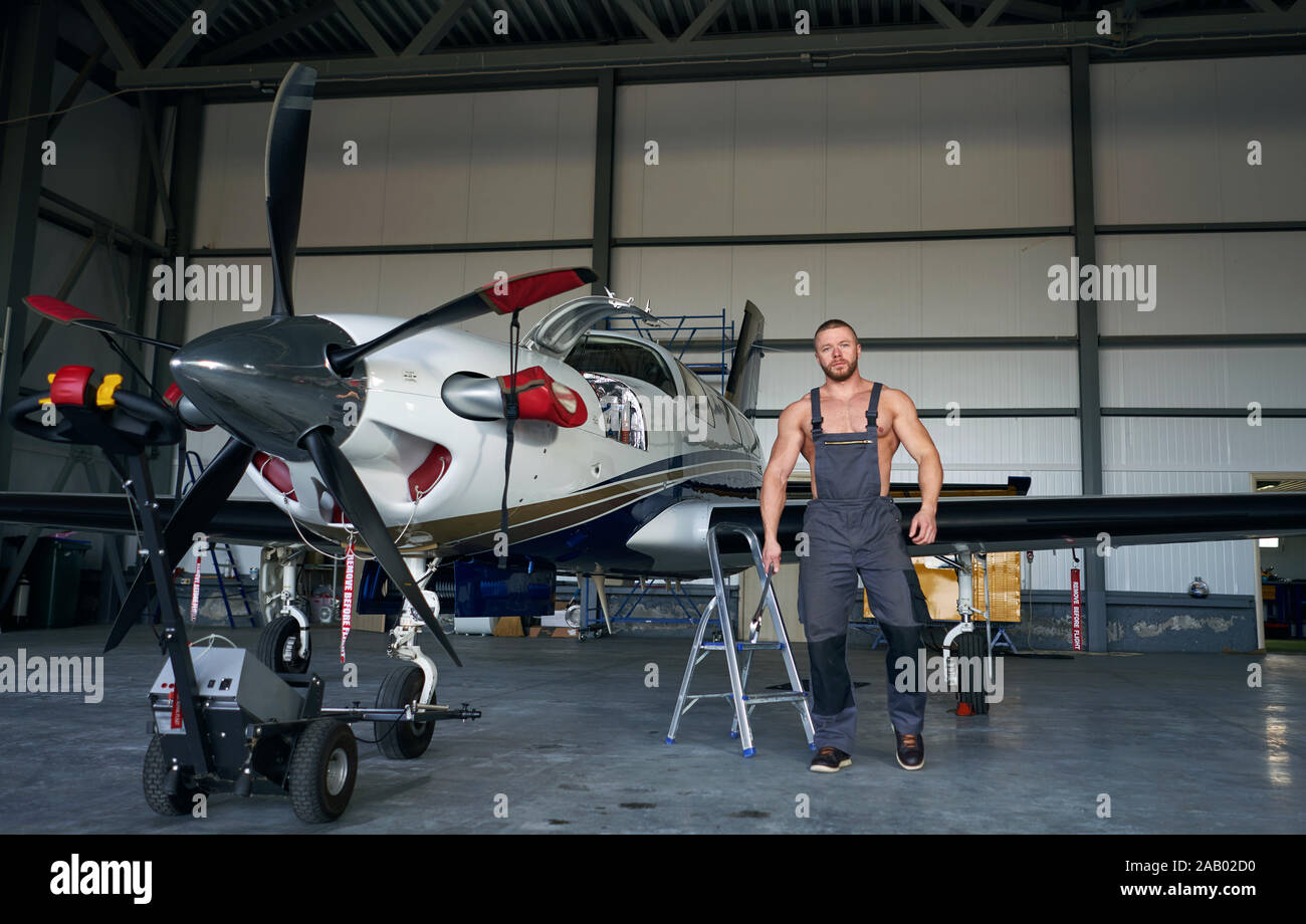 technician in the hangar with the plane Stock Photo - Alamy