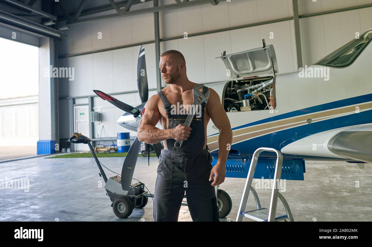 technician in the hangar with the plane Stock Photo - Alamy