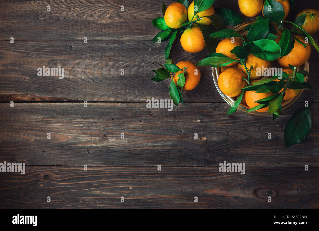 Fresh organic tangerines with leaves on rustic wooden background. Top ...