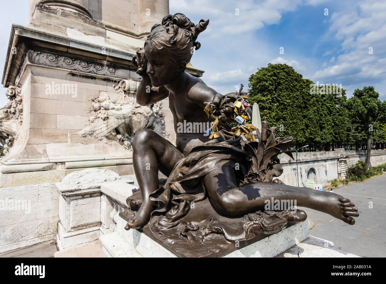 A statue of Nereid by Arthur Massoulle with attached padlocks on Pont ...