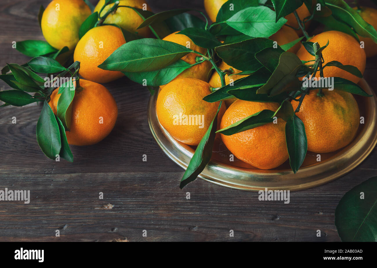 Fresh organic tangerines with leaves on rustic wooden background Stock ...