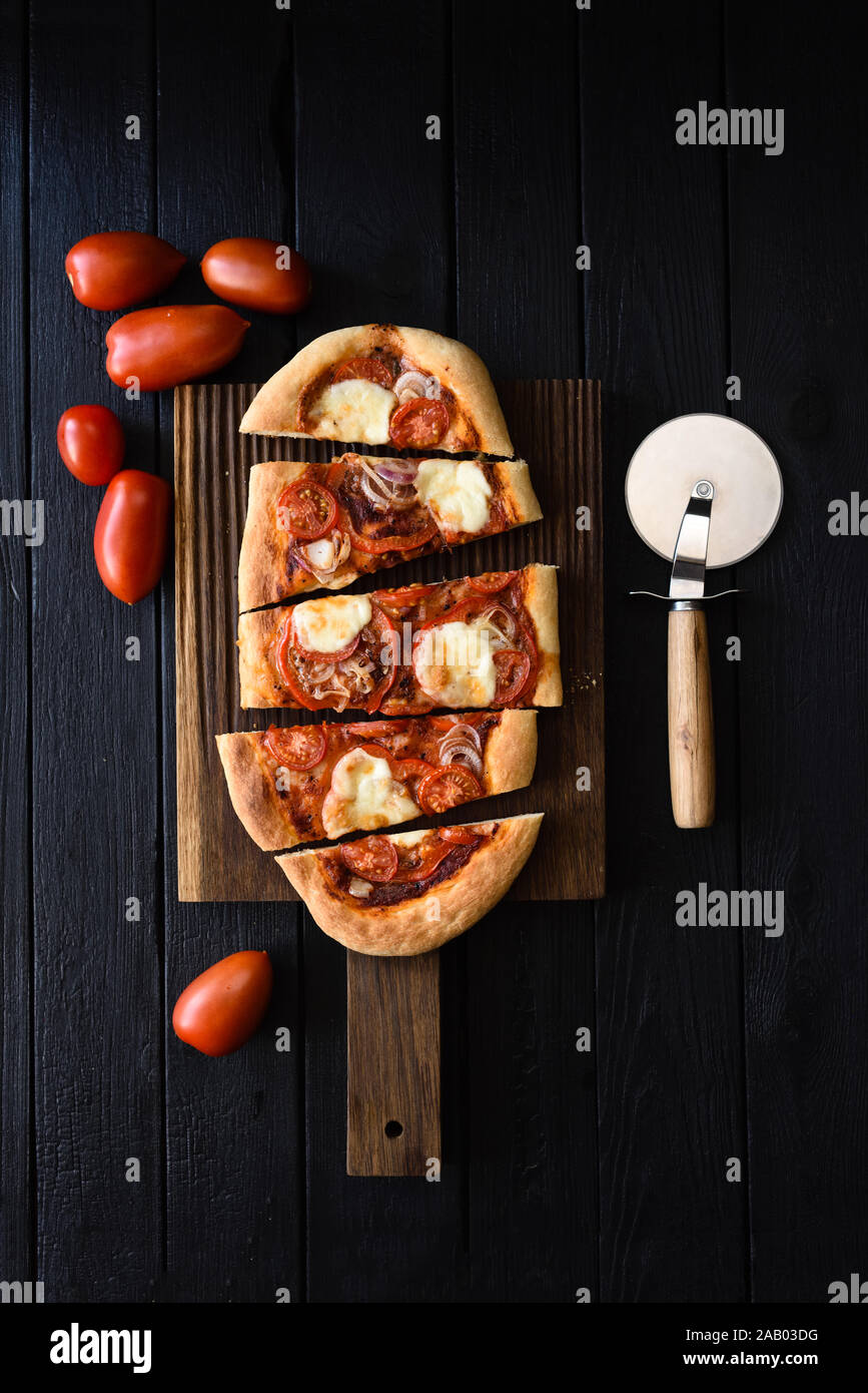 Homemade vegetarian pizza. Freshly baked oval pizza with tomatoes and ...