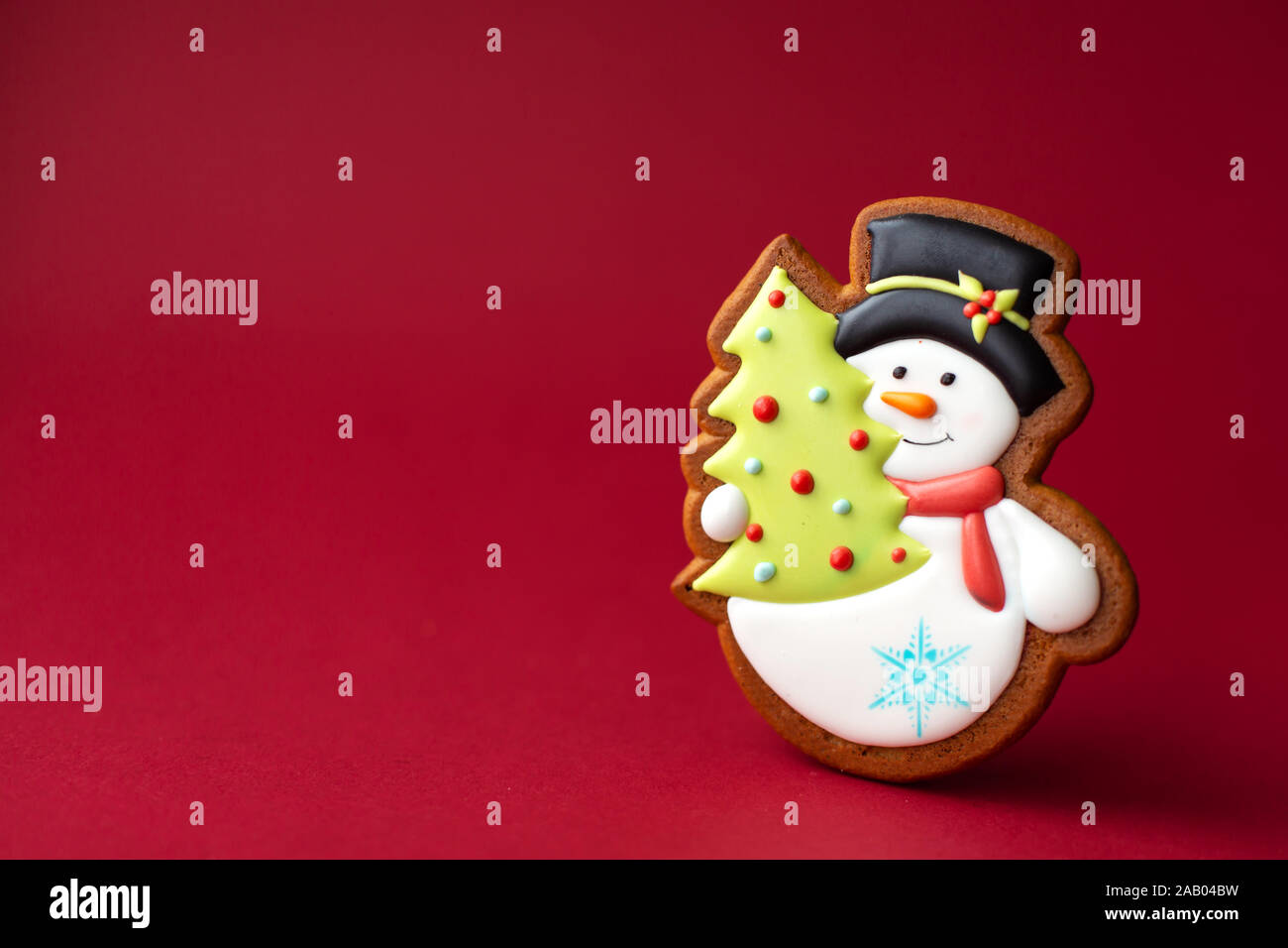 gingerbread cookie of cute snowman on red background. Traditional ...