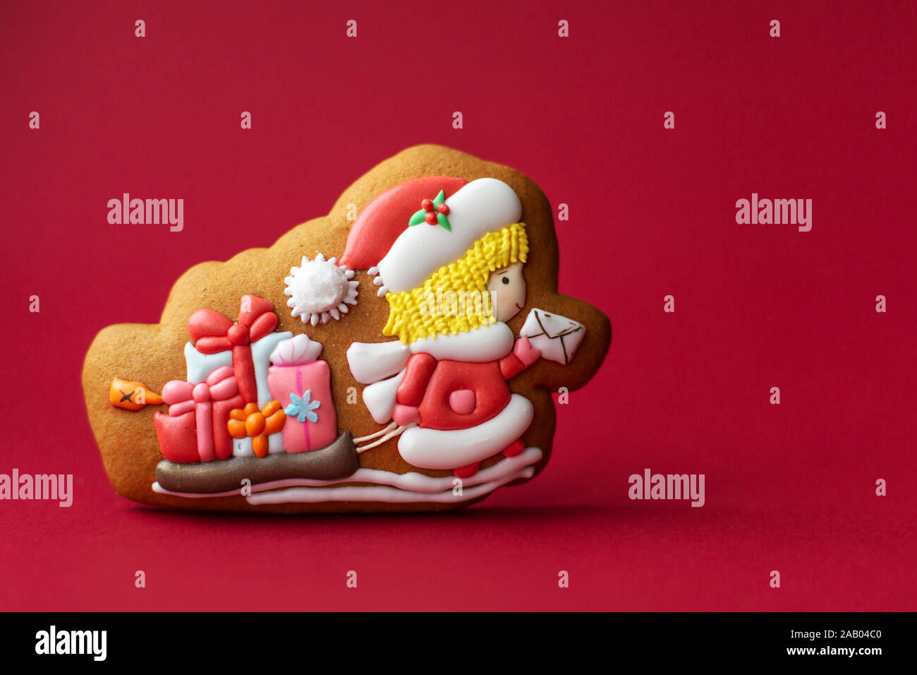 gingerbread cookie of Santa postman on red background. Traditional ...