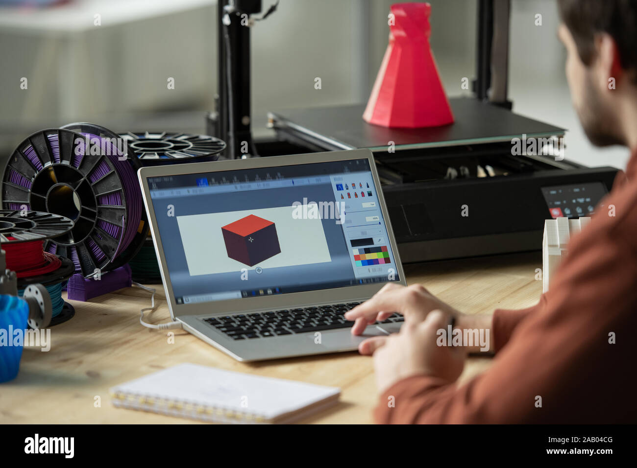 Creative designer working over new 3d model on laptop screen before ...