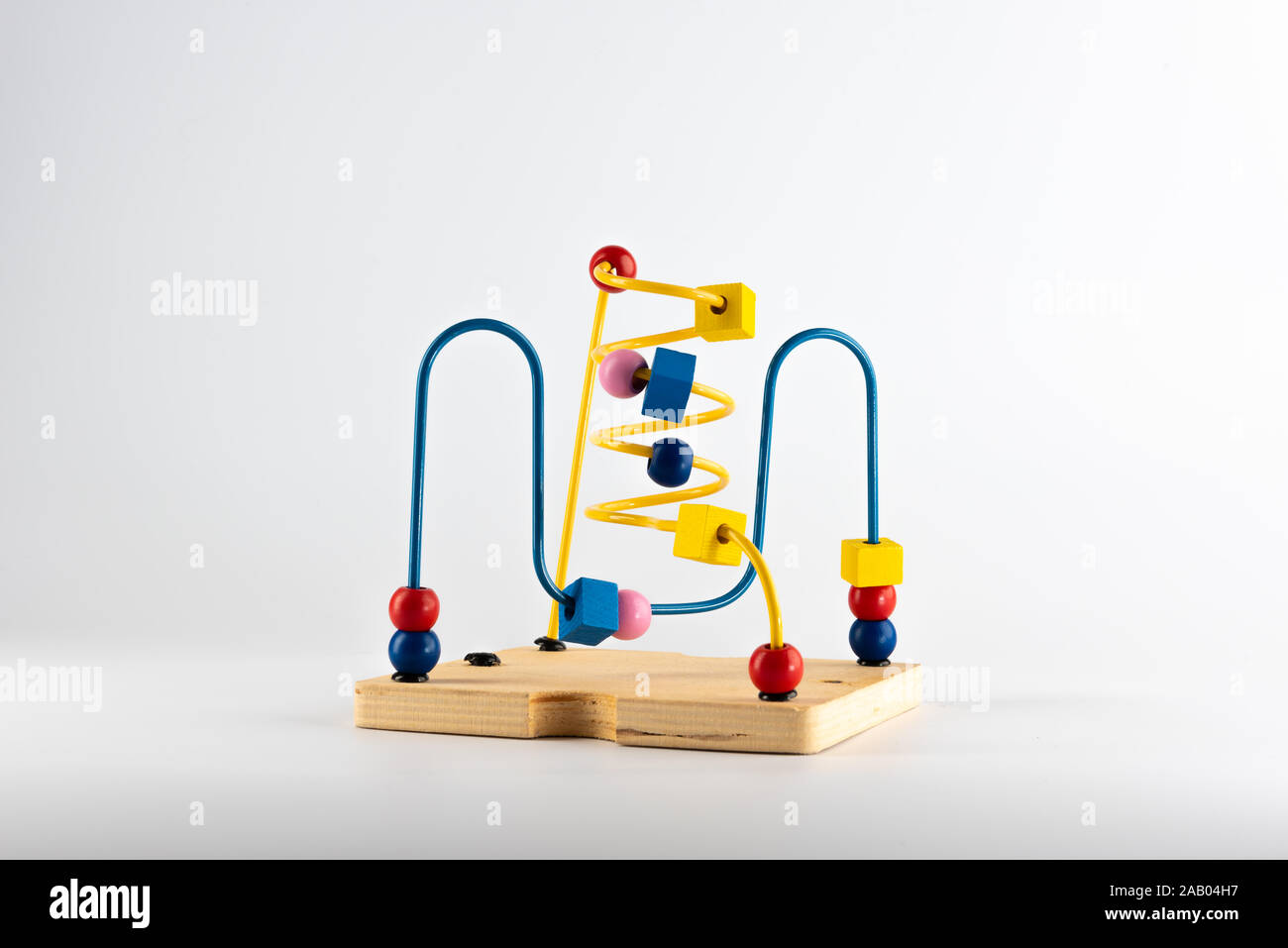 A small child's development toy with wires and charms isolated against ...