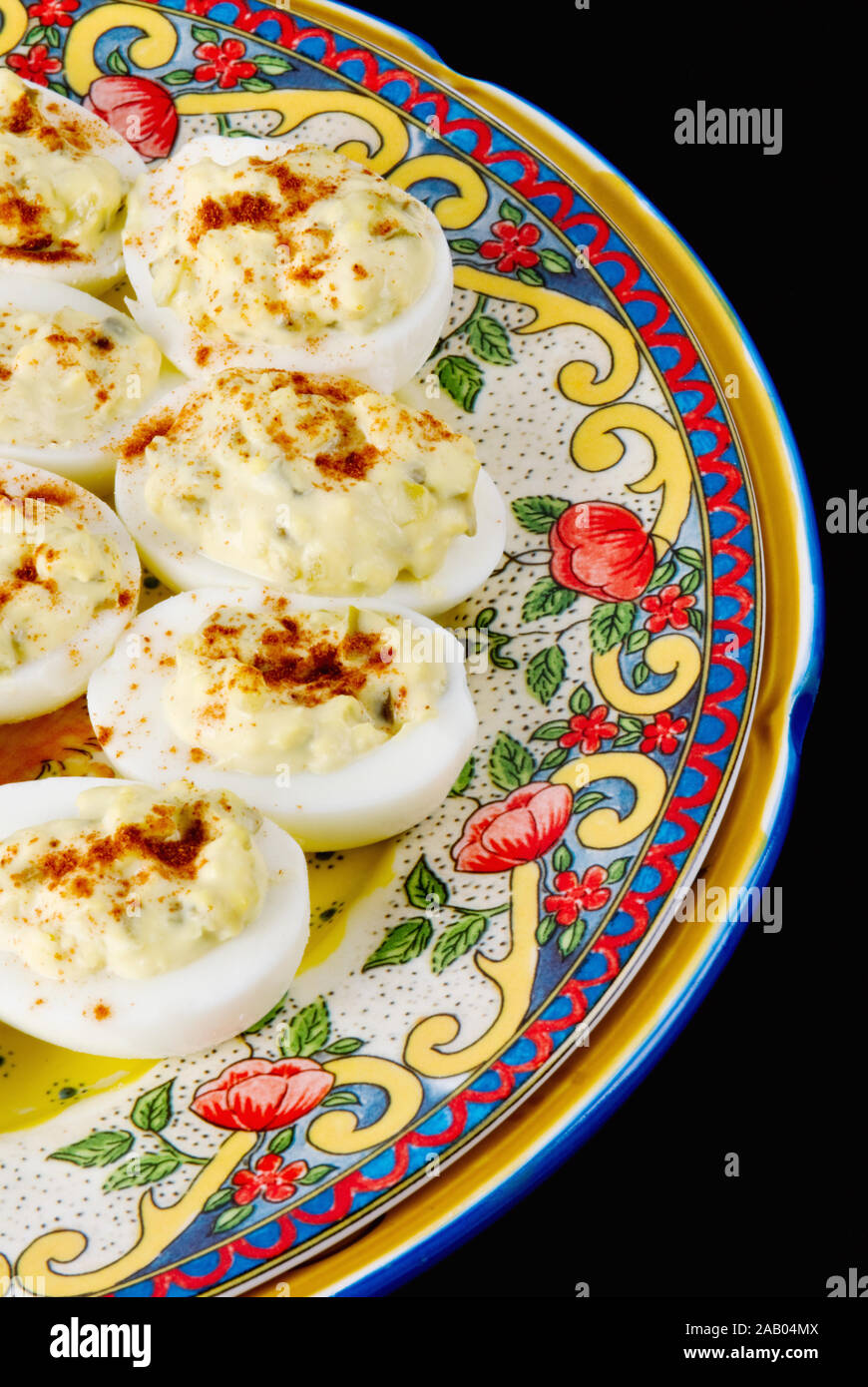 Homemade deviled eggs that are garnished with red paprika and served on ...