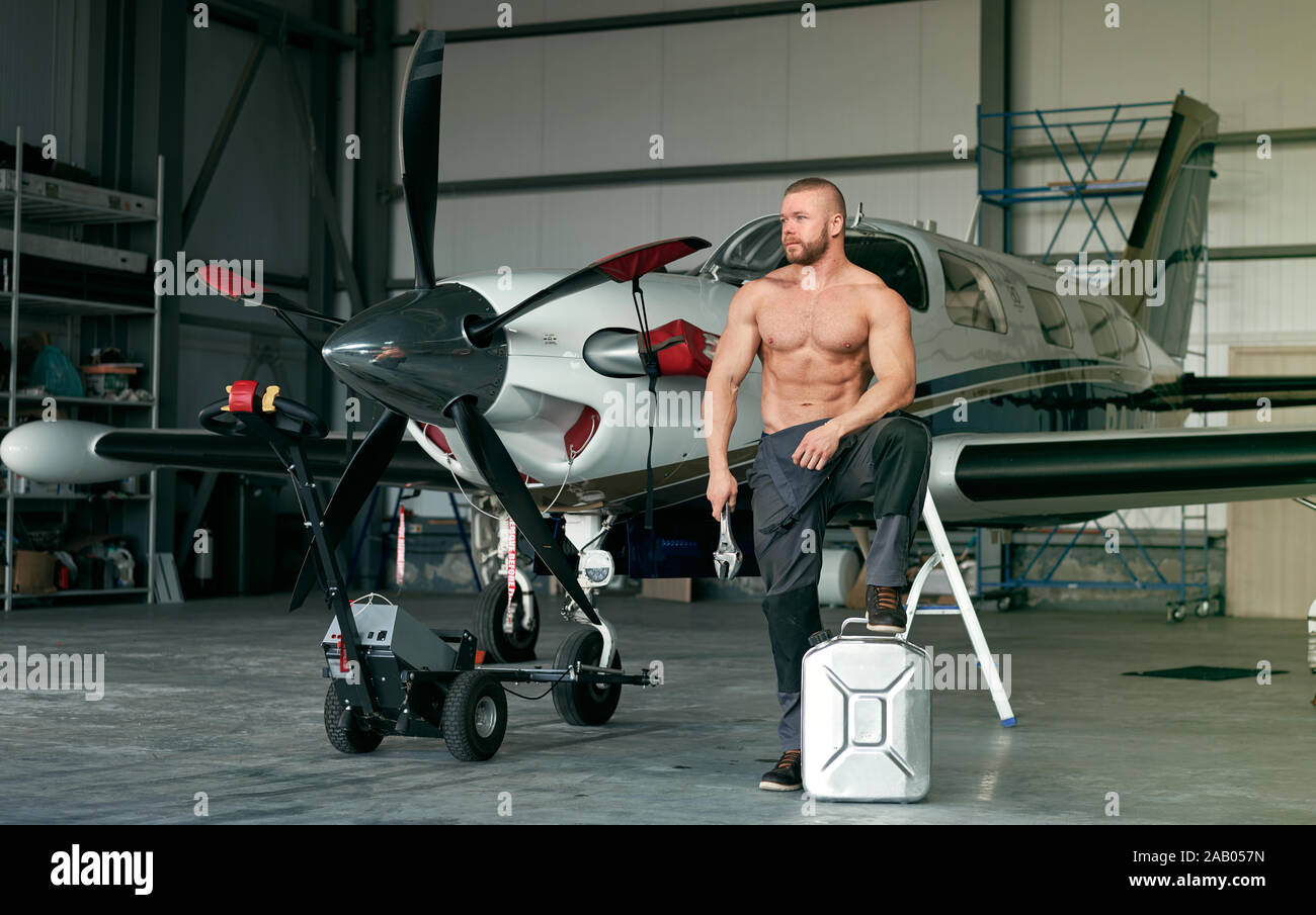 technician in the hangar with the plane Stock Photo - Alamy