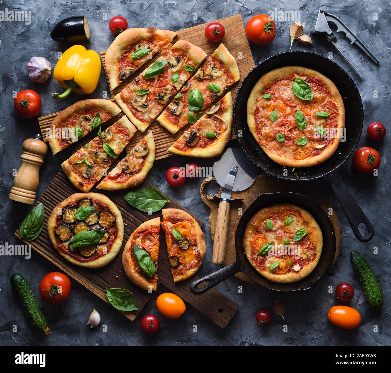 Flatlay of healthy rustic vegetarian pizza party. Homemade pizzas with ...