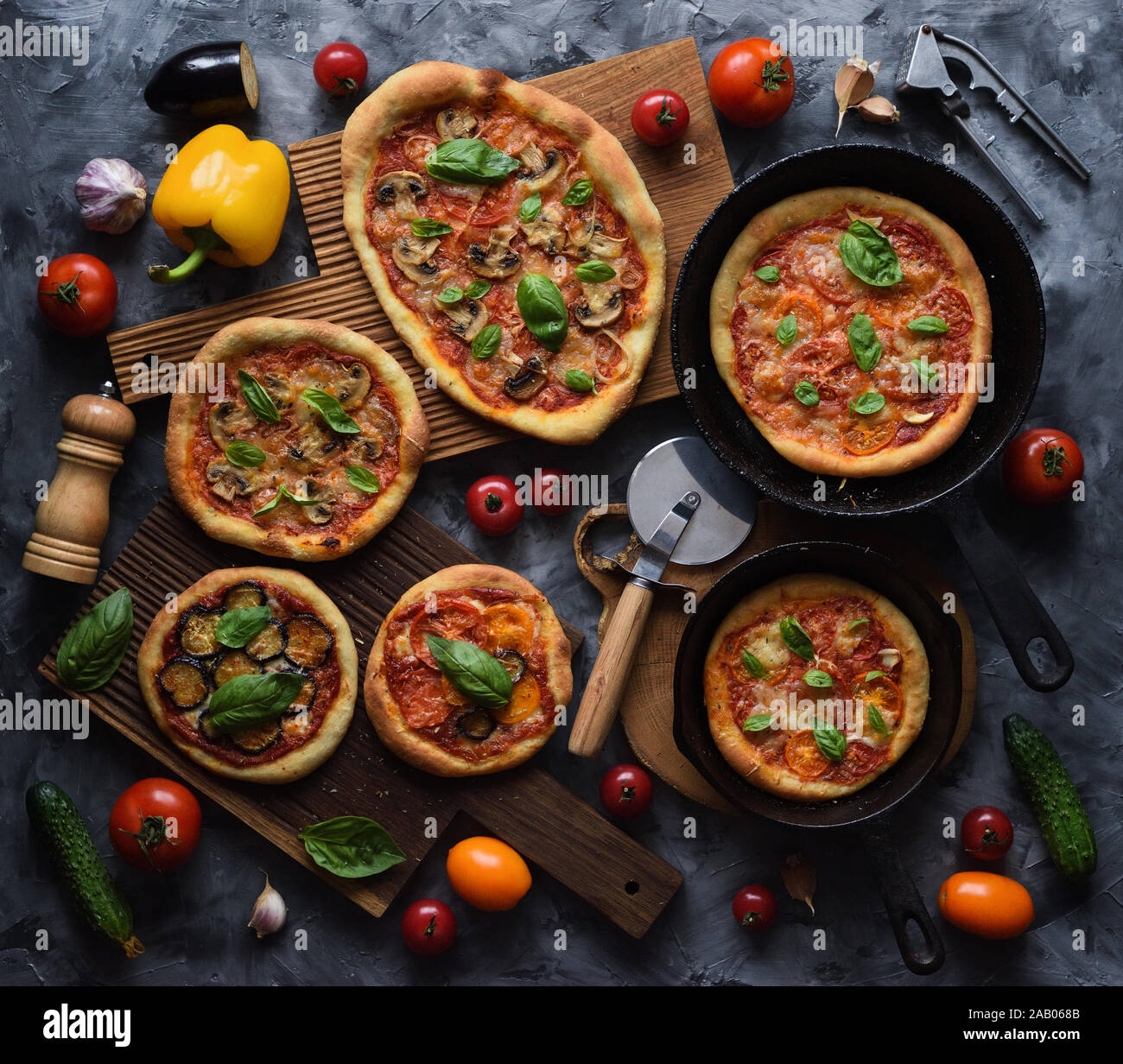 Healthy rustic vegetarian pizza party. Homemade pizzas with tomatoes ...