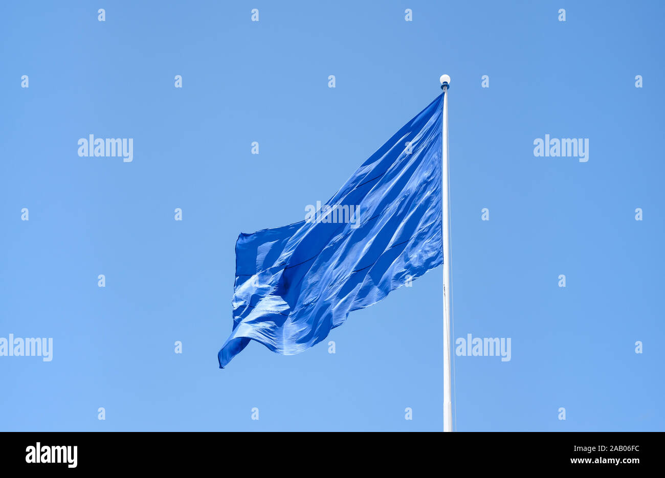 waving blue flag on blue sky Stock Photo - Alamy