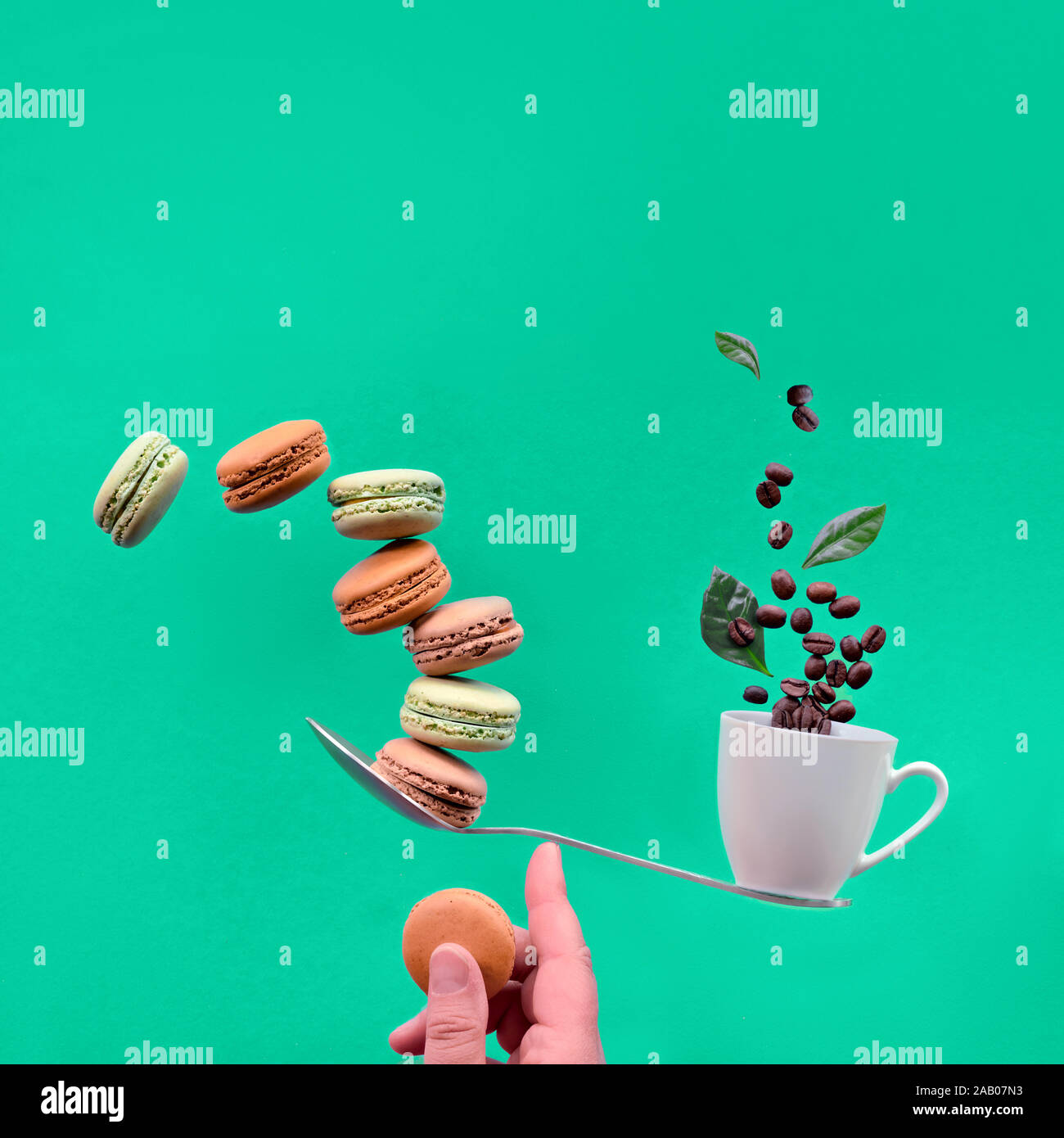 Perfect balance concept. Balancing cup of coffee and macaronos on index ...