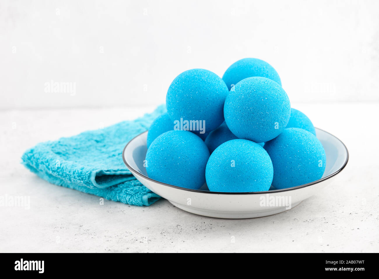 Blue bath bombs in plate on white tabletop, close up view Stock Photo ...